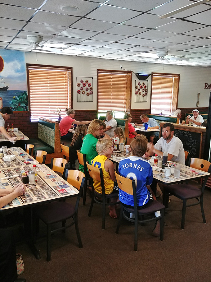 Counter seating: where regulars exchange local news while watching the breakfast ballet unfold behind the scenes.