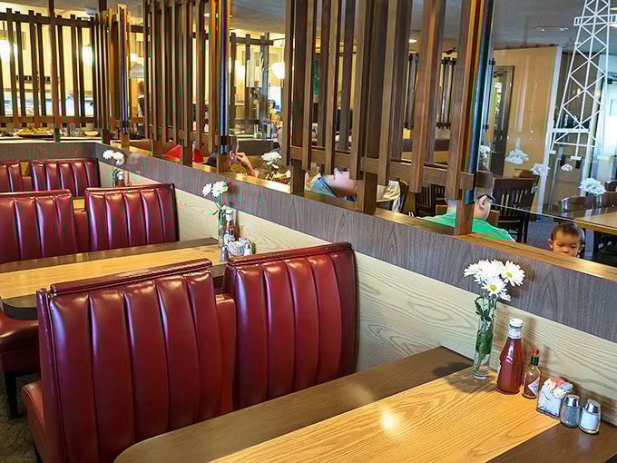 Wood dividers create intimate dining spaces where food-induced happiness spreads from table to table like a delicious contagion.