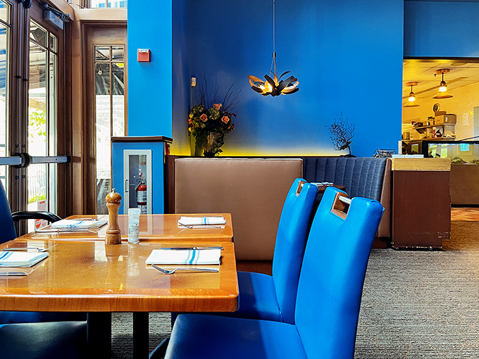 Bold blue walls and warm wood create dining spaces that feel both intimate and social—like your favorite dinner party without having to do dishes.