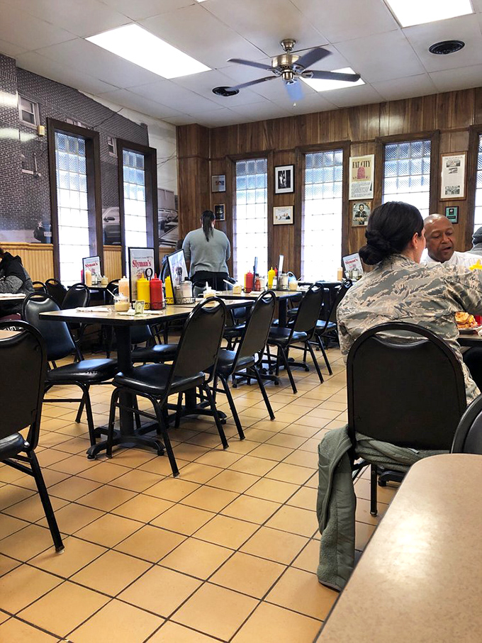 Wood paneling and memorabilia create the perfect backdrop for serious sandwich consumption – no distractions, just deliciousness.