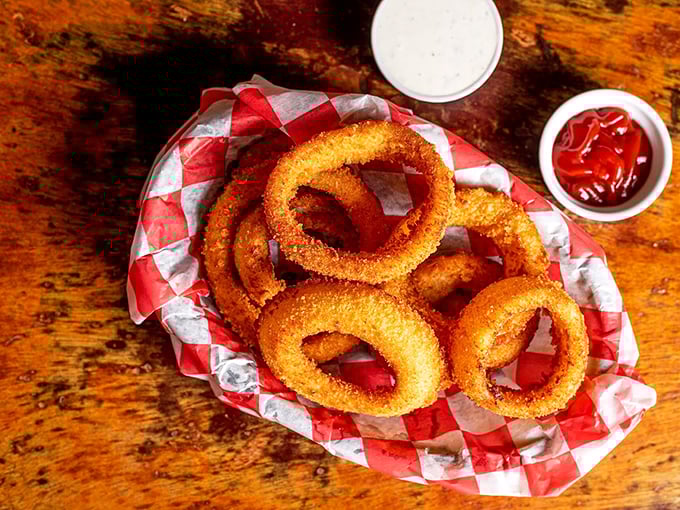 Golden halos of crispy perfection. These onion rings aren't just sides—they're the main event masquerading as supporting characters.
