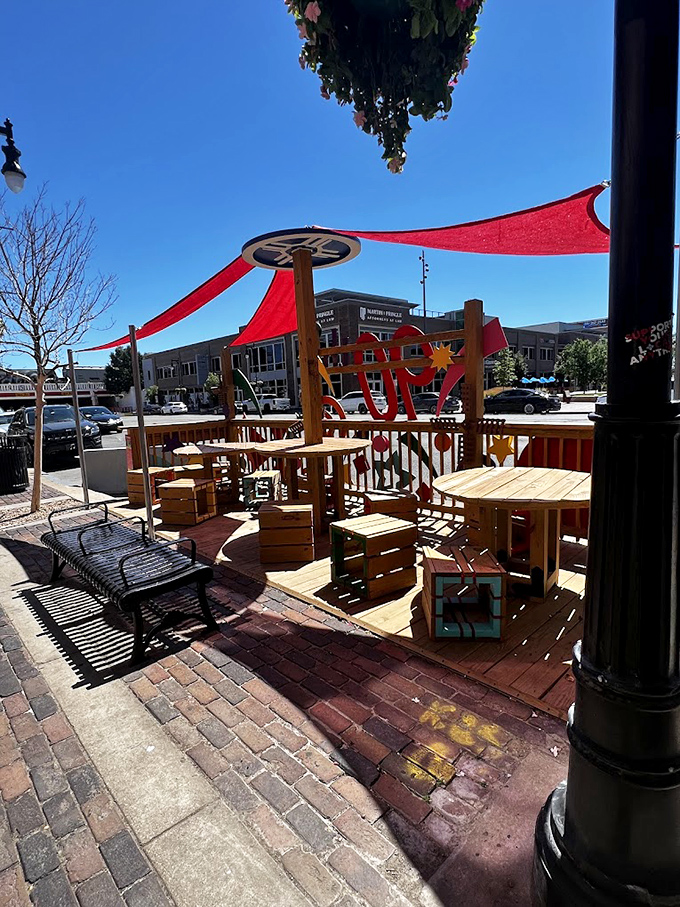 Outdoor seating where Kansas sunshine becomes an ingredient in your meal, with red awnings providing just enough shade for perfect people-watching conditions.