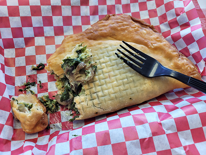 Peek inside this savory fried pie and discover a world of greens and goodness tucked into that golden crust.