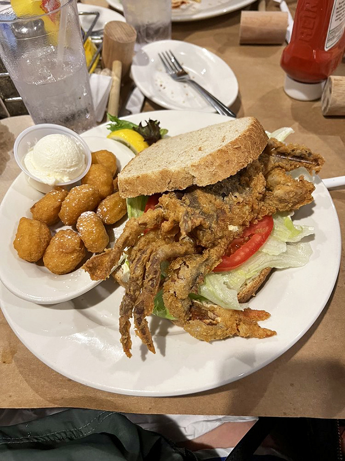The soft shell crab sandwich—where the entire crab, crispy legs and all, becomes a delicious reminder that sometimes more is definitely more.