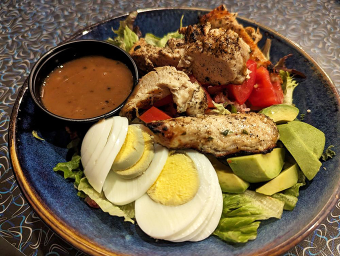A salad that proves vegetables can party too—especially when dressed up with chicken, eggs, and avocado in their Sunday best.