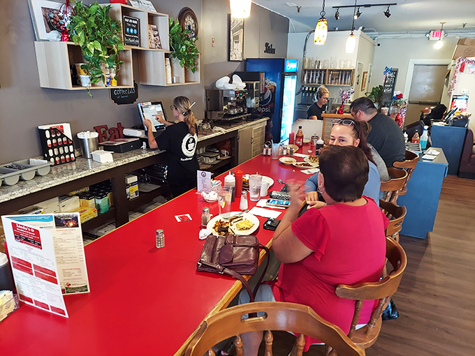 The counter offers breakfast theater in the round, where regulars know the best seats combine optimal coffee refill positioning with prime people-watching.