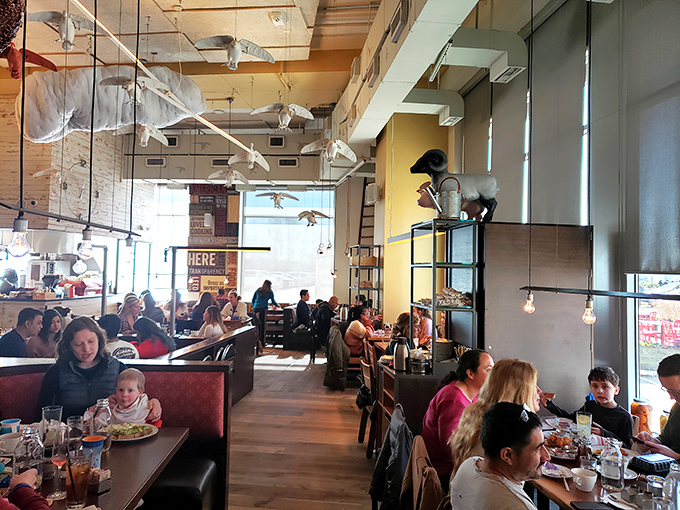 The bustling dining room hums with conversation and clinking plates. Families and friends gather under quirky farm-inspired décor for memorable meals.