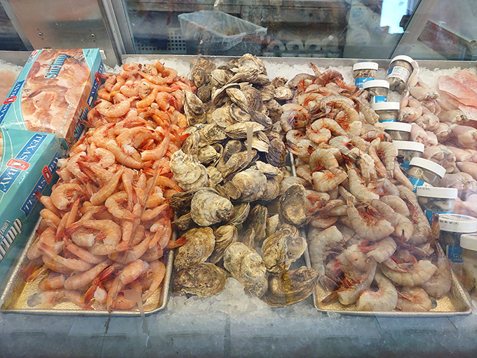 Fresh seafood displayed with the pride of an artist's gallery opening—shrimp, oysters, and fish awaiting their transformation.