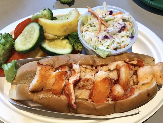 The Connecticut-style hot lobster roll—butter-kissed chunks of lobster meat on a perfectly toasted roll. No mayo needed when you respect the ingredients this much.