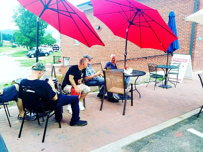 Under bright pink umbrellas, locals gather to solve the world's problems one cup of coffee at a time.