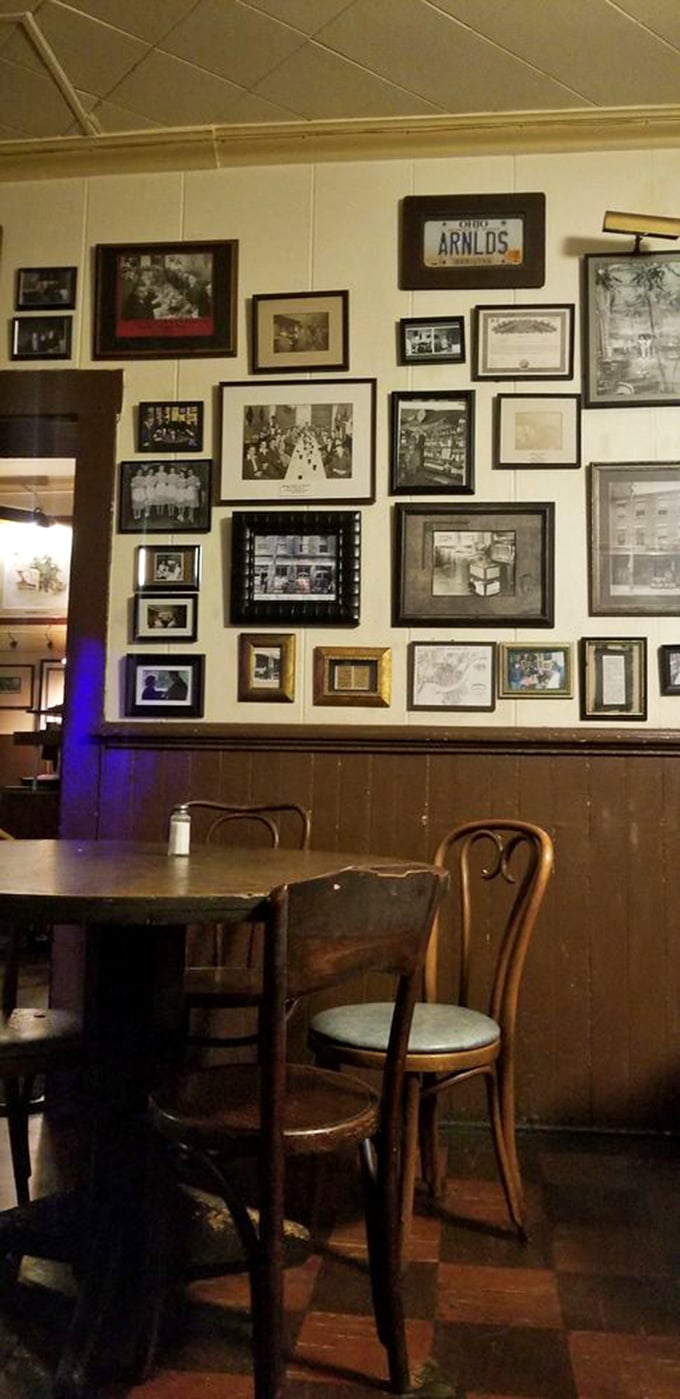 The photo wall serves as Arnold's family album—generations of memories, celebrations, and that one guy who nobody remembers inviting but everyone was glad came.