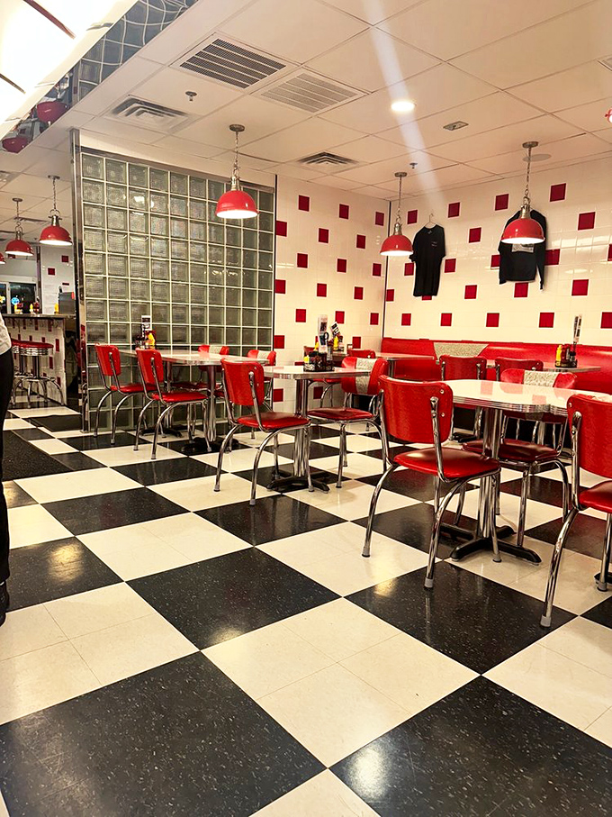 Red chairs stand at attention against the classic diner backdrop, each table a stage where countless food dramas have unfolded.