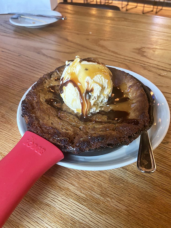 A skillet brownie topped with ice cream and caramel that doesn't just end your meal—it provides closure, therapy, and a moment of pure dessert bliss.