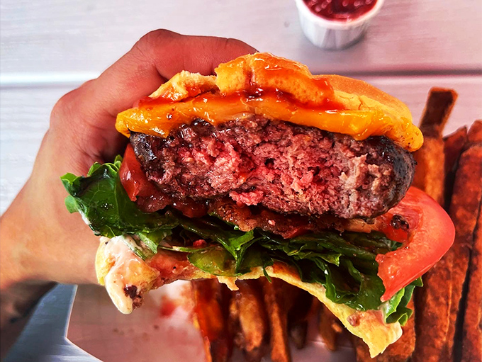 The money shot—a perfect cross-section revealing the ideal pink center. This is burger engineering at its finest.