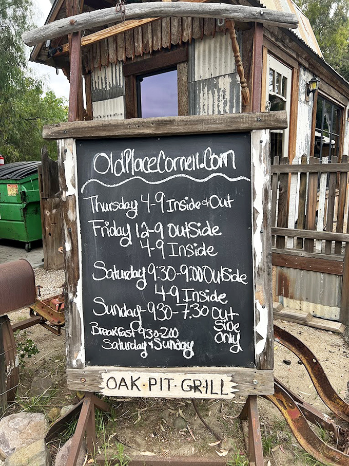 Hours scrawled on a chalkboard—because places with character don't need digital displays. "Oak Pit Grill" says everything you need to know.