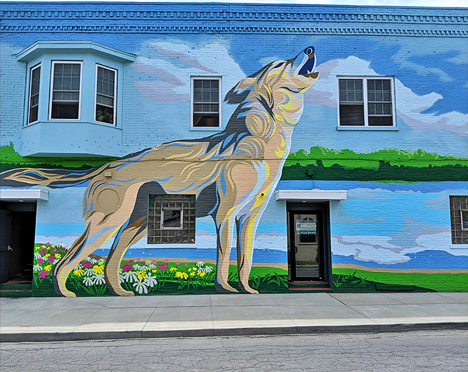 That wolf isn't howling—it's calling you to dinner. The mural that launched a thousand appetites in downtown Fort Wayne.
