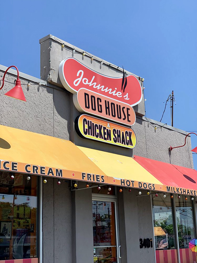 The sign shines like a beacon of hope for hungry travelers, promising salvation in the form of perfectly fried comfort food.