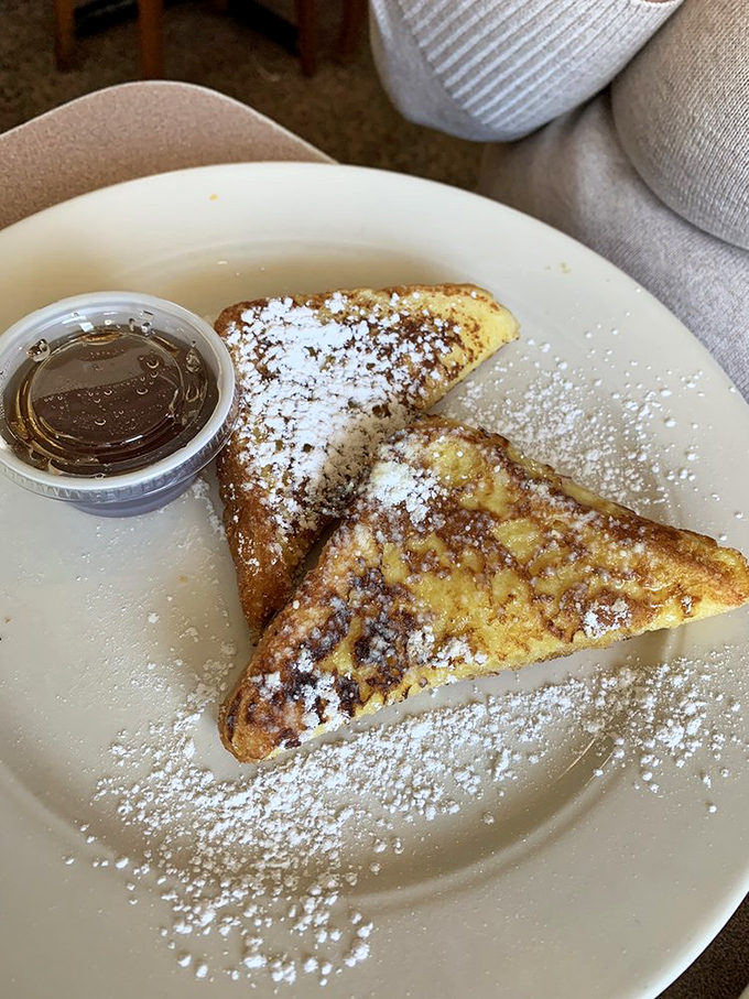 French toast that doesn't need a passport to transport you to breakfast bliss, dusted with powdered sugar like freshly fallen snow.