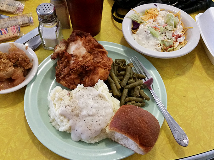 The holy trinity of comfort food: crispy fried chicken, creamy mashed potatoes with gravy, and green beans – served with a side of nostalgia.