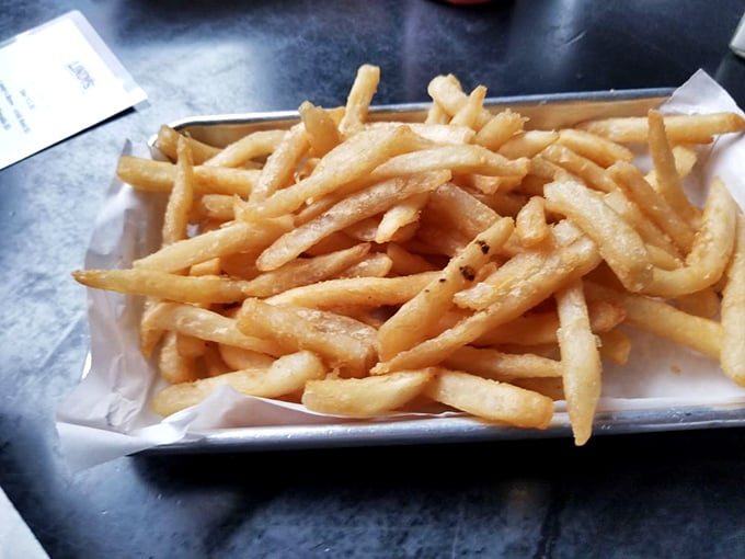 Perfect fries—crisp outside, fluffy inside—stand ready for dipping, scooping, or emergency carb support when your burger becomes overwhelming.