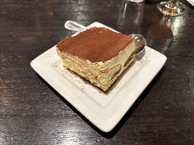 Tiramisu that doesn't need to show off—it sits there calmly, dusted with cocoa, knowing full well it's about to become the highlight of your day.