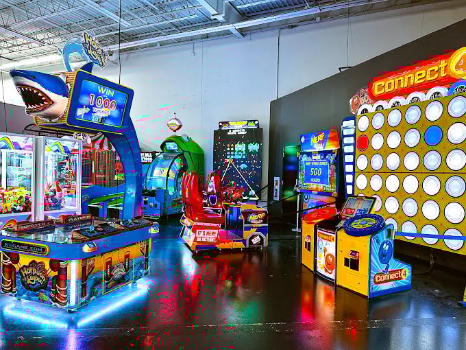 The arcade—where you can continue competing even after your forearms give out from white-knuckling the steering wheel for twelve laps.