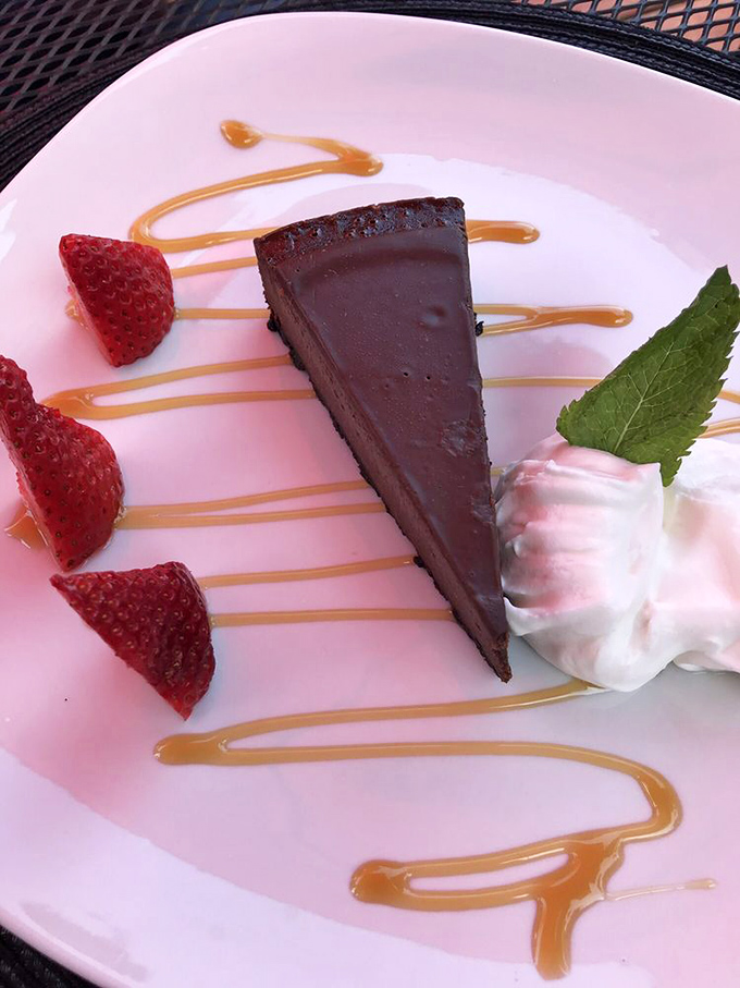 This chocolate dessert isn't just cake—it's the final argument in the case for why you should move to Harpers Ferry immediately. The strawberries are just showing off.