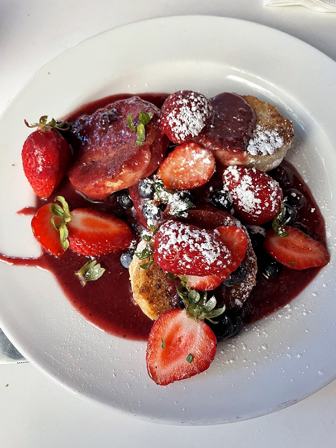 These aren't your grandmother's biscuits—unless your grandmother was a pastry chef who studied in Paris. The berry sauce gleams like edible rubies.