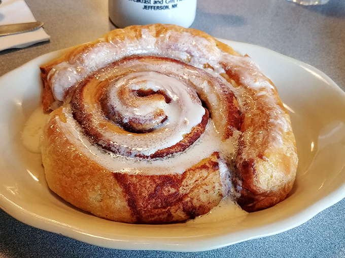 This cinnamon roll isn't just breakfast—it's edible architecture. The spiral design leads your eyes to the center where all that gooey goodness awaits.