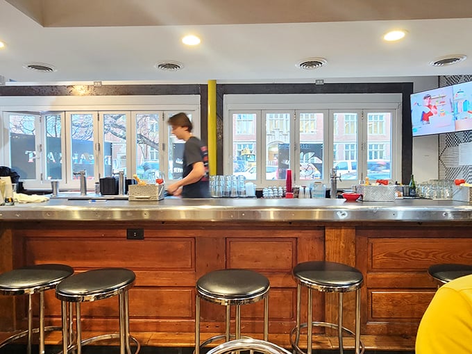 The counter where breakfast dreams come true—a front-row seat to the choreographed chaos of short-order cooking at its finest.