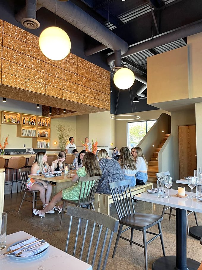 The true measure of a great restaurant: tables filled with people leaning in, glasses raised, caught in that magical moment of shared culinary joy.