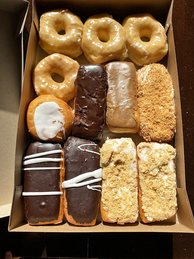 A dozen donuts arranged with mathematical precision, like a delicious sudoku puzzle you solve with your taste buds instead of a pencil.