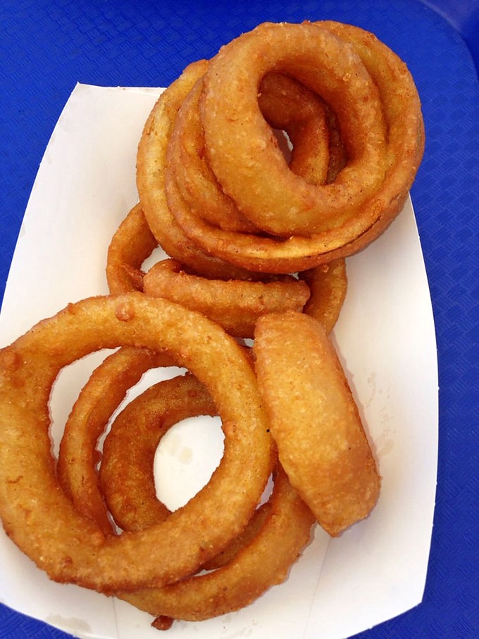 Onion rings that achieve that mythical balance—crispy enough to crunch, tender enough to bite through cleanly. Seafood's perfect sidekick.