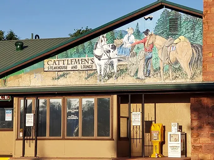 The western mural at Cattlemen's isn't just decoration—it's a promise of the authentic beef experience waiting inside.