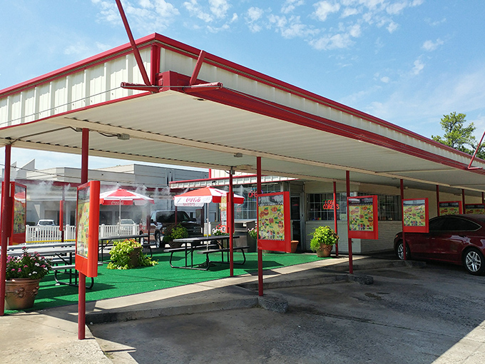 That iconic red-trimmed canopy isn't just shelter – it's a time portal to when dinner came with roller skates and optimism.