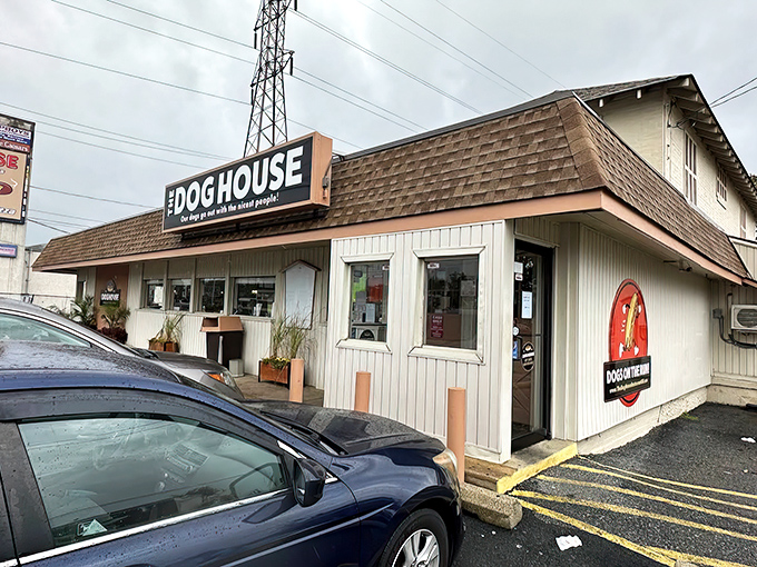 The Dog House's iconic sign promises a time-traveling hot dog experience. Simple exterior, extraordinary flavors waiting inside.