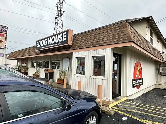 The Dog House's iconic sign promises a time-traveling hot dog experience. Simple exterior, extraordinary flavors waiting inside.