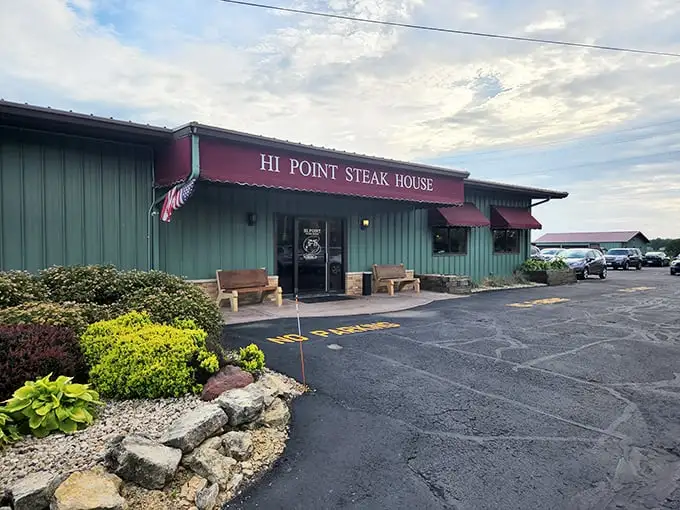 The green exterior of Hi Point Steakhouse is like a secret handshake – unassuming on the outside, sizzling perfection inside.