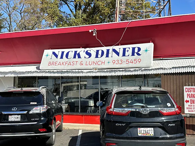 Nick's Diner exterior beckons with its cherry-red awning – like finding the ruby slippers on your quest for perfect pancakes.
