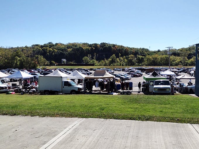 The parking lot transforms into a bargain bazaar under clear Kansas skies—early birds with coffee cups strategically plotting their treasure map.