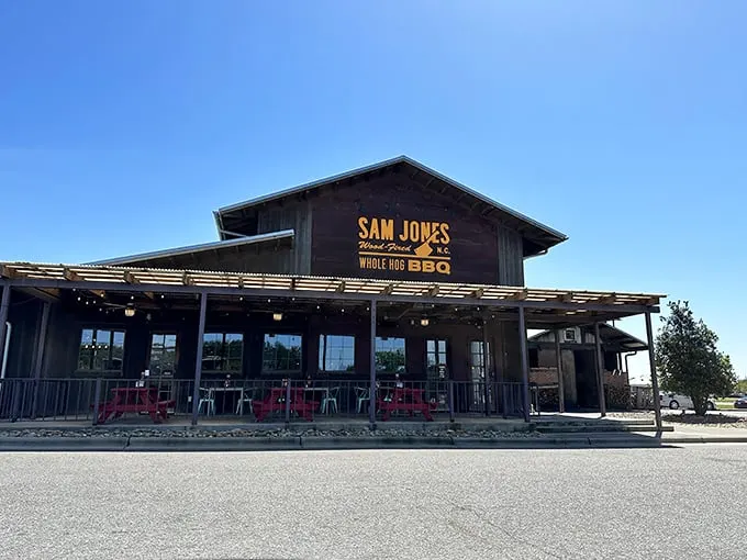 Where tradition meets innovation – Sam Jones BBQ's welcoming porch practically whispers "come sit a spell" before the meat sweats begin.