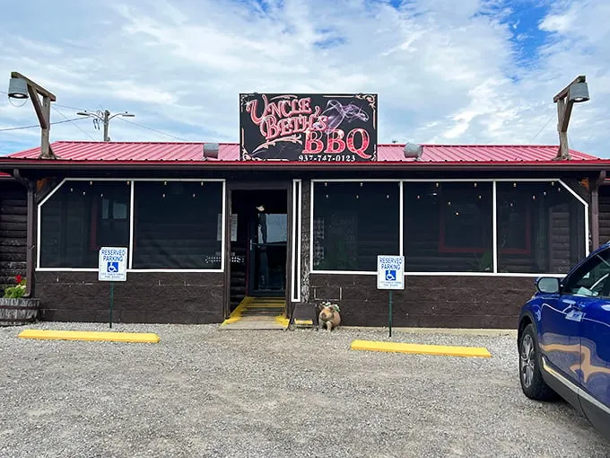 Uncle Beth's BBQ exterior beckons like a rustic barbecue beacon, promising smoky treasures within those log cabin walls.
