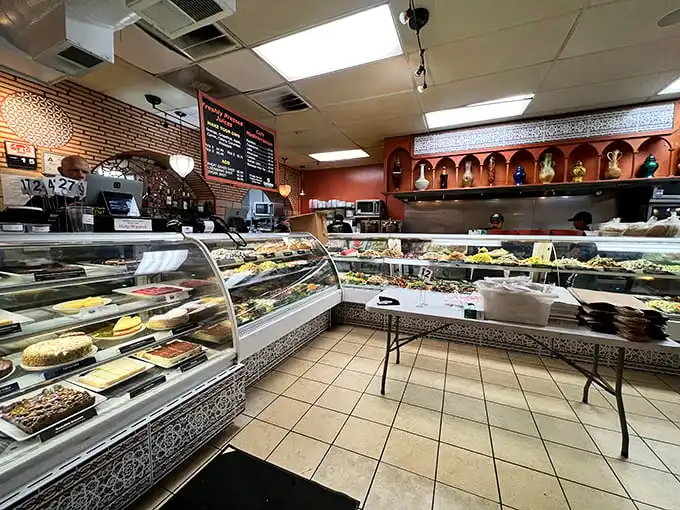 Food paradise doesn't need fancy décor—just look at this display case! Rows of vibrant Mediterranean delights wait patiently for their moment of glory on your plate.
