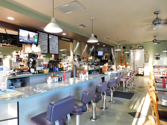 Classic diner counter seating—where the breakfast magic happens. Those purple swivel stools have witnessed more morning revelations than a therapist's couch.