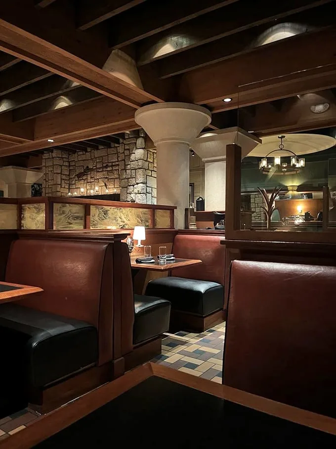 Leather booths form intimate cocoons where carnivorous dreams come true. That amber lighting isn't accidental—everyone looks better when contemplating a perfect steak.