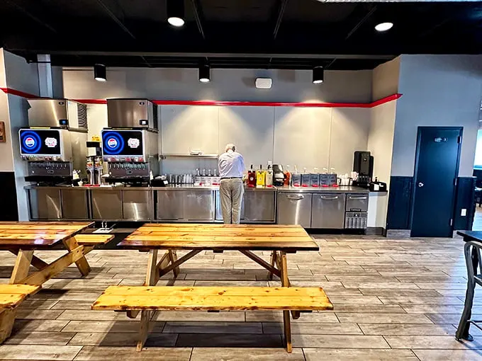 Simple wooden picnic tables invite you to focus on what matters—the meat, not the marble countertops. This is democracy in dining.