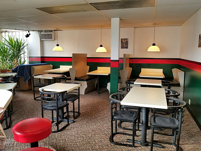 No-frills dining at its finest—where the décor whispers "focus on your food" and the red and green stripes remind you that Italy's flavors await.