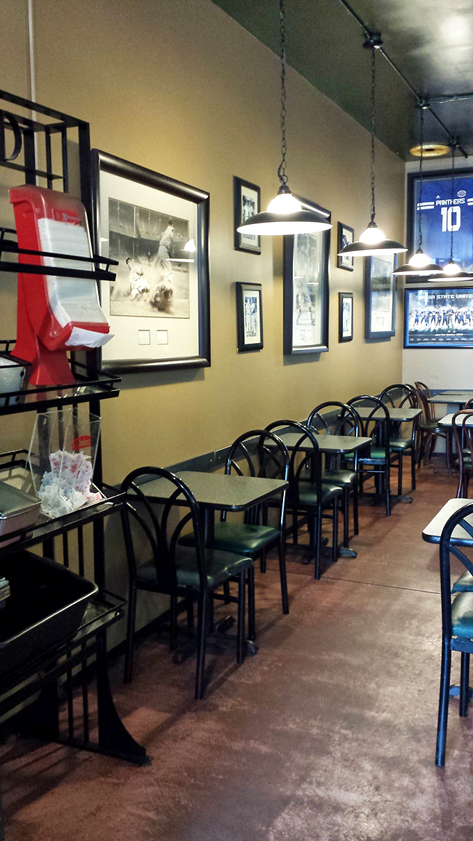 Simple tables, sports memorabilia, and pendant lighting create that perfect neighborhood vibe. No pretension here—just a sanctuary for serious sandwich lovers.