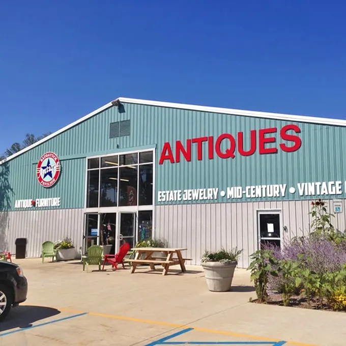 Colorful outdoor seating welcomes visitors to this treasure trove, where lavender and greenery soften the industrial exterior—your first hint that this isn't ordinary antiquing.