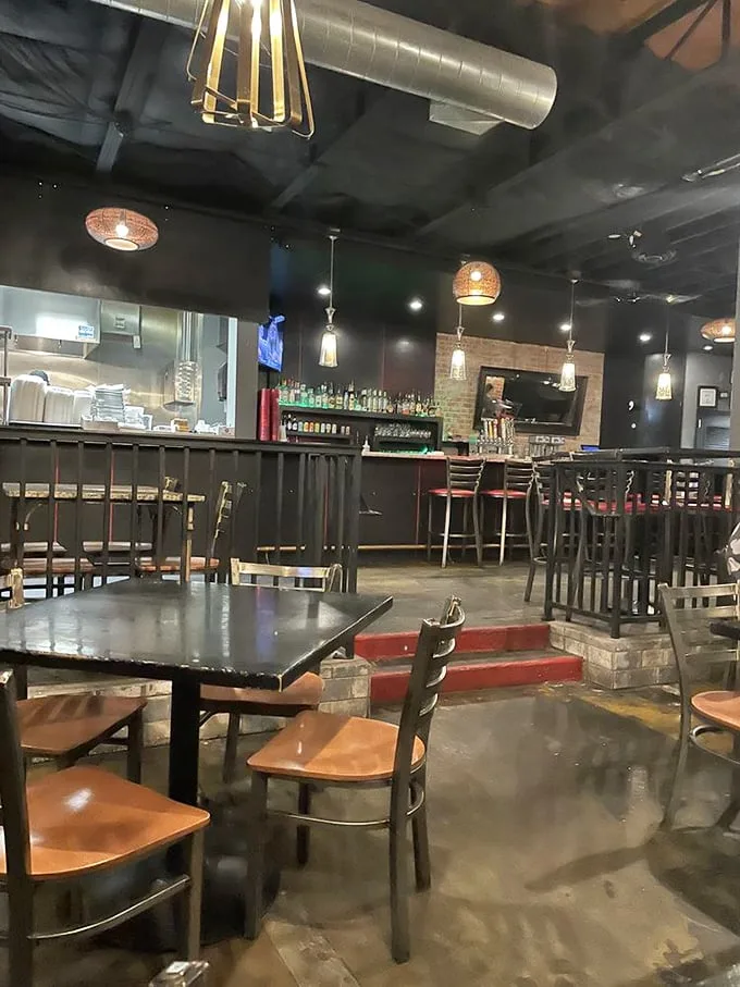 Industrial-chic meets burger joint comfort inside Lindy's, where pendant lighting casts a warm glow over tables soon to be graced by towering creations.